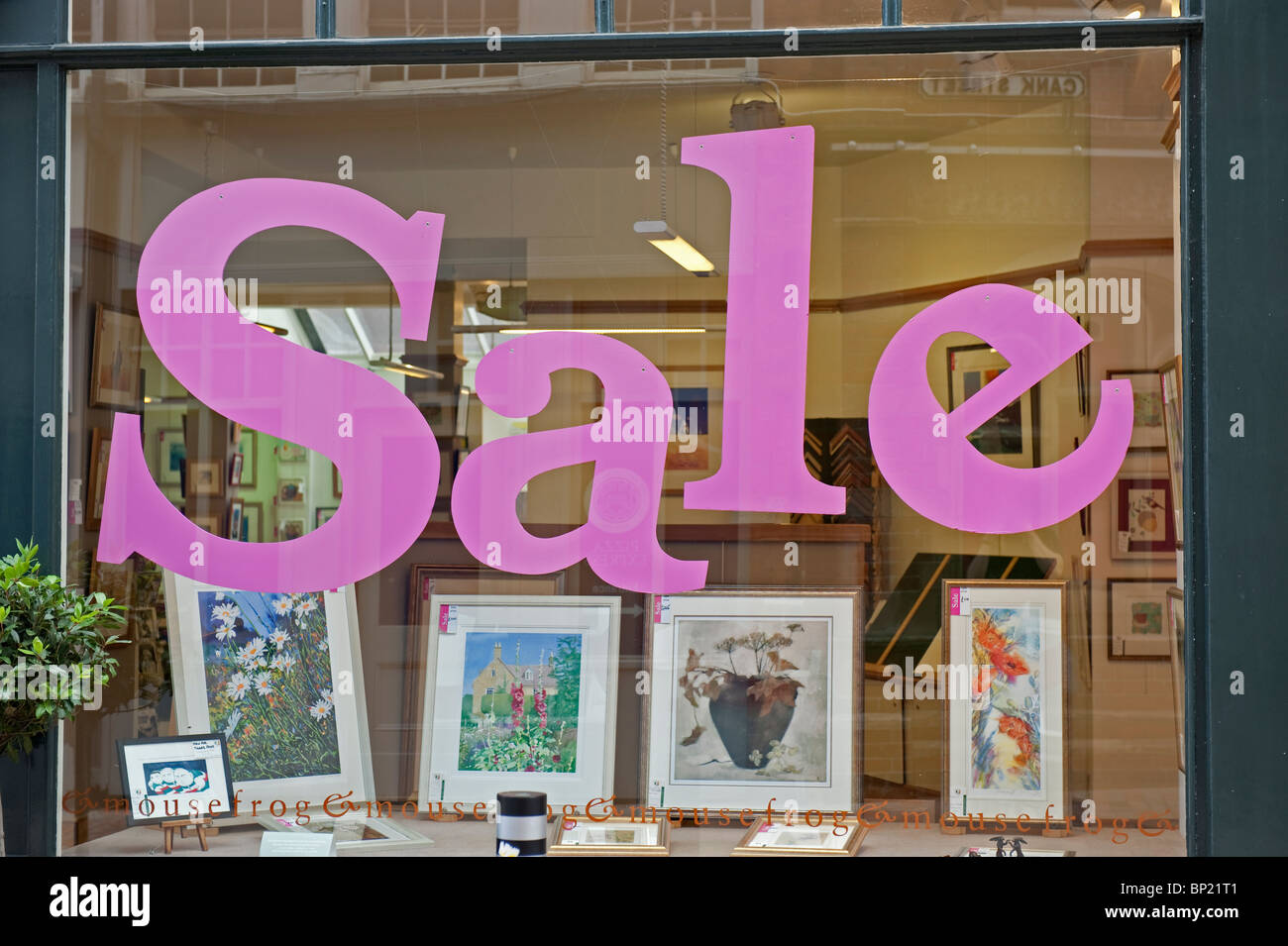 Pink sale sign in a window display of an art gallery Stock Photo - Alamy