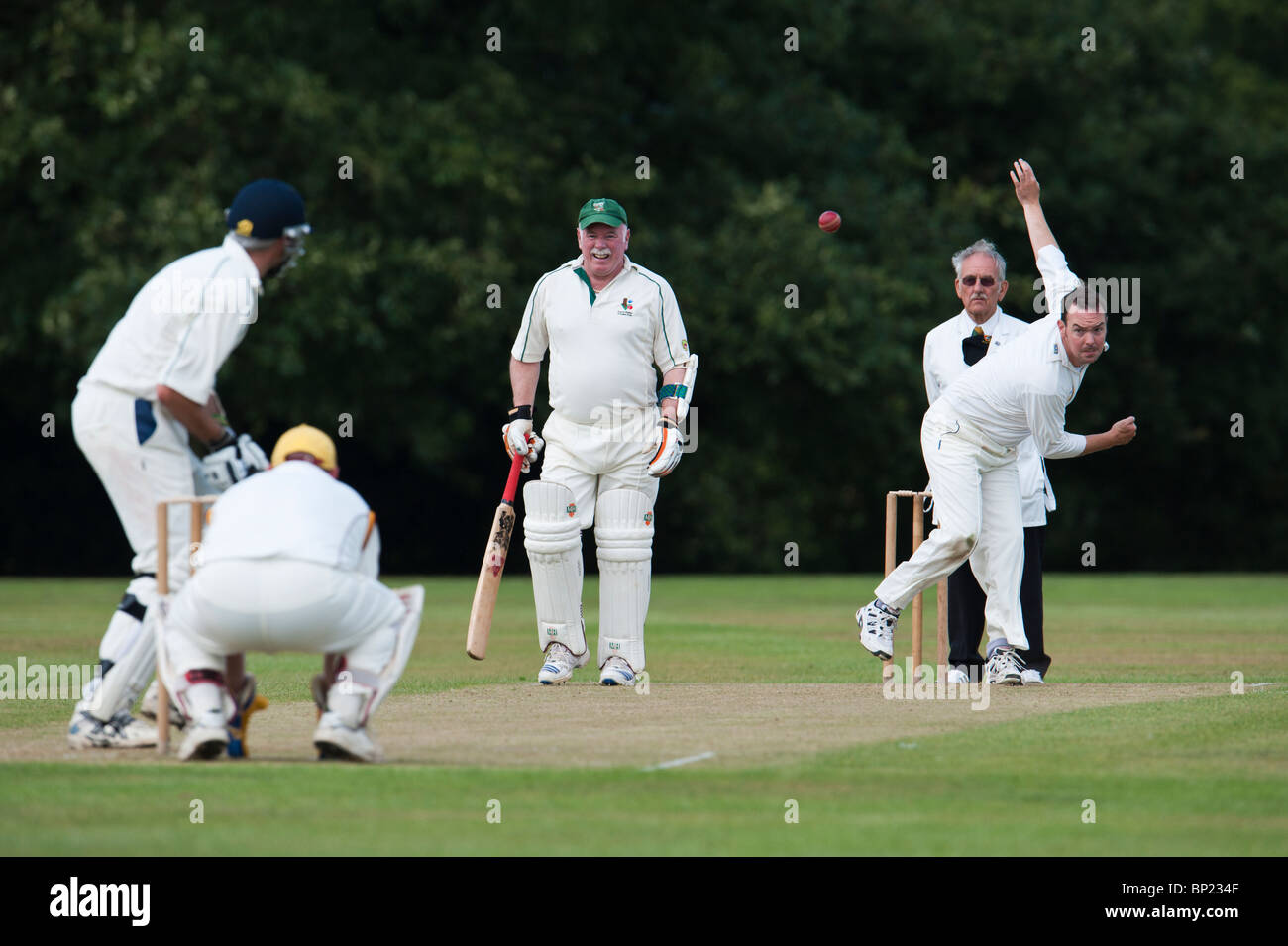 Cricket match bowler in action Stock Photo - Alamy