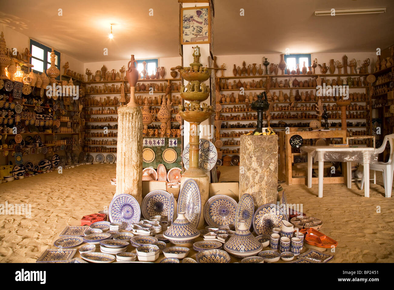 Pottery is sold in a shop in the village of Guellala on the island of ...