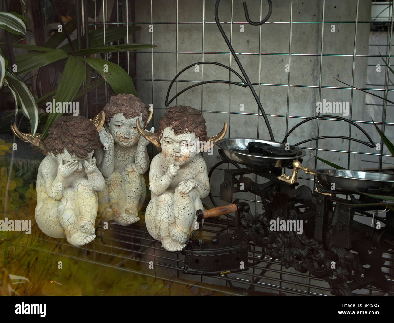 Three porcelain angels in a shop-window Stock Photo - Alamy