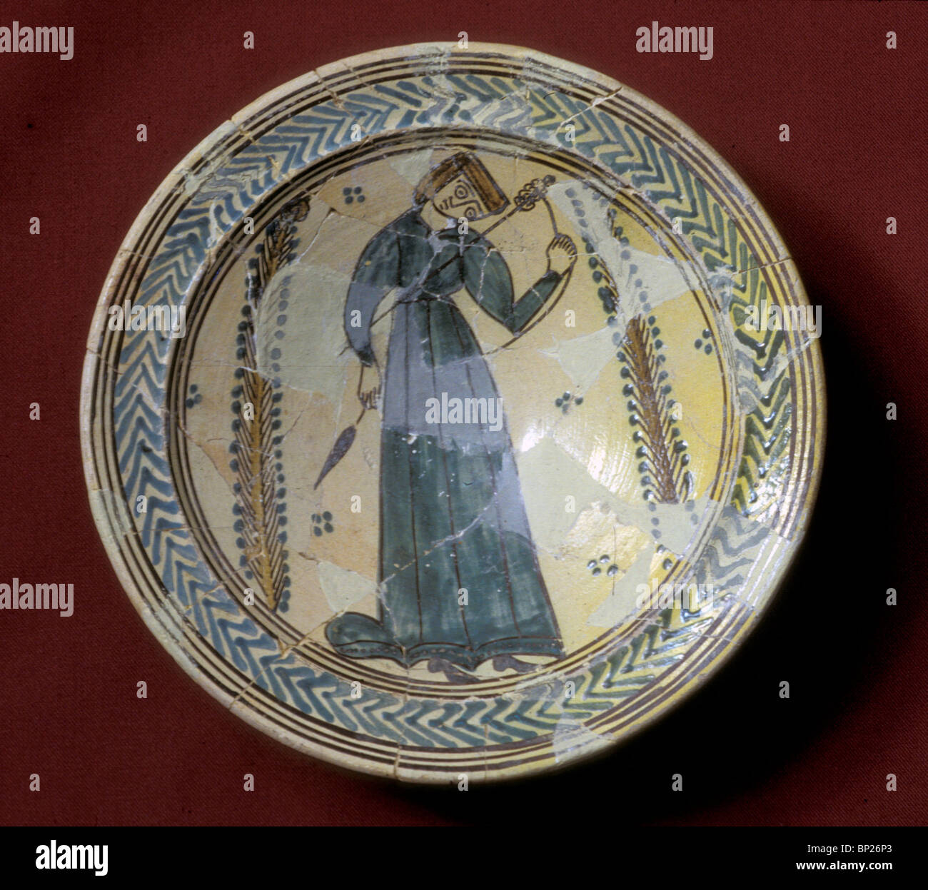 1229. CRUSADER PERIOD PAINTED CERAMIC PLATE DEPICTING A WOMAN SPINNING ...