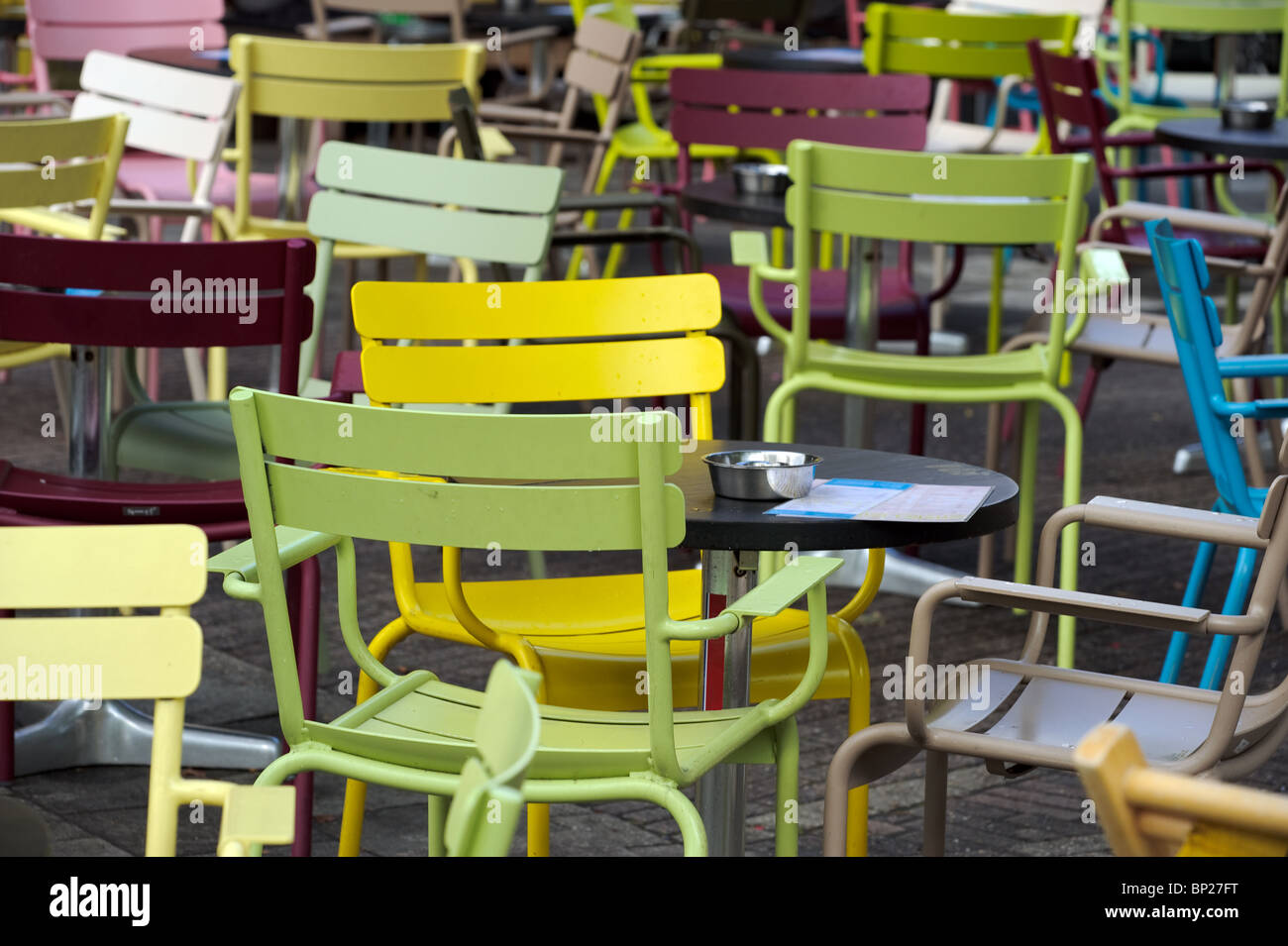 Colorful chairs at an outdoor cafe Stock Photo - Alamy