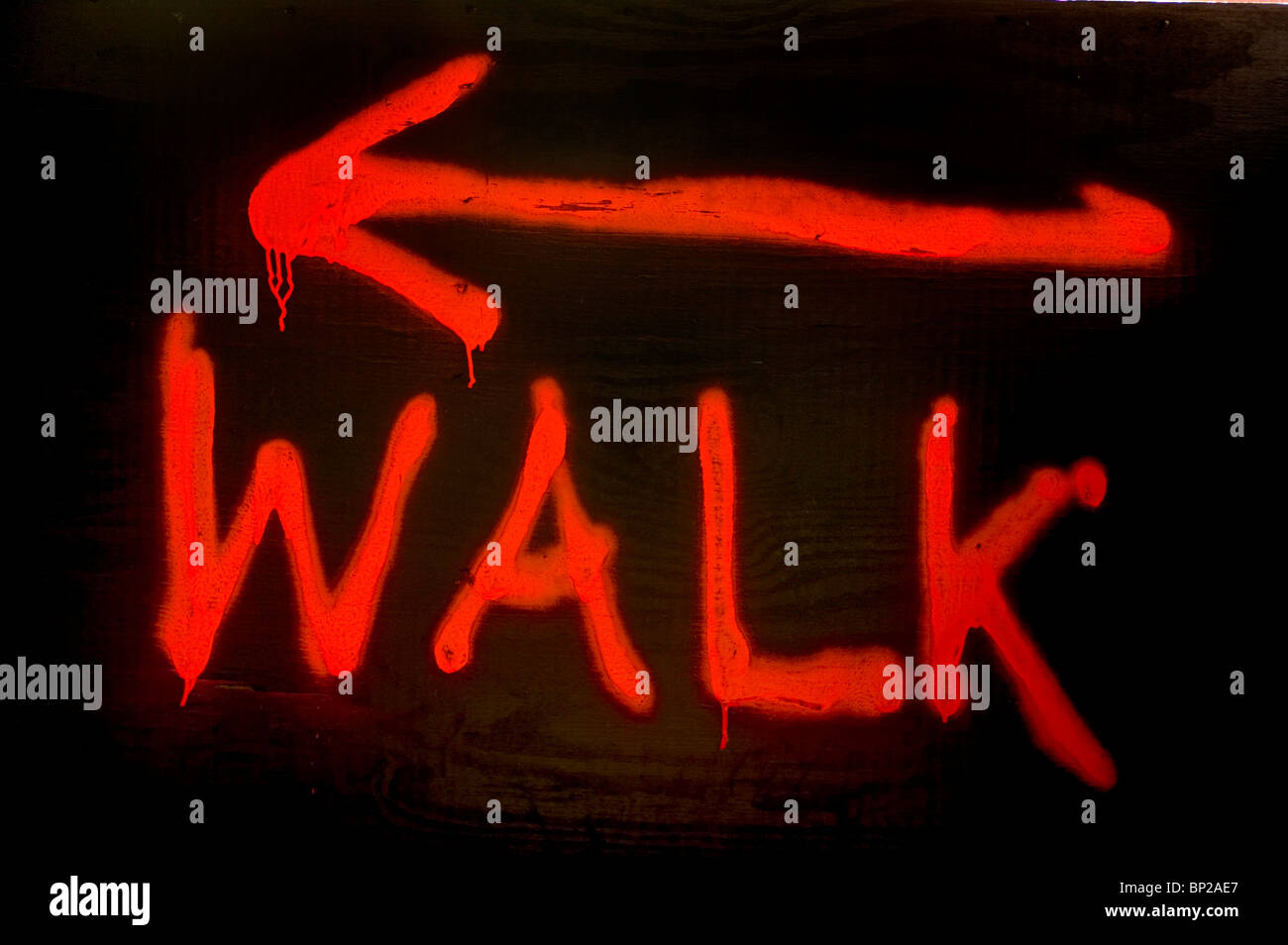Red painted walk sign on a building site directing pedestrians on 42nd ...