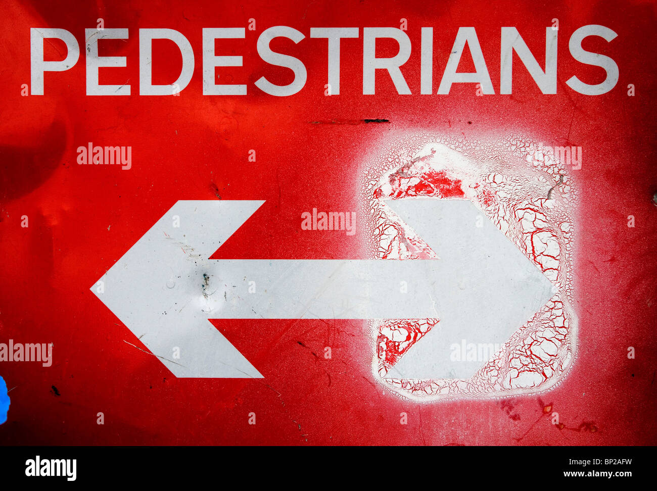 Red pedestrian sign with a white arrow pointing bothways, but one way ...