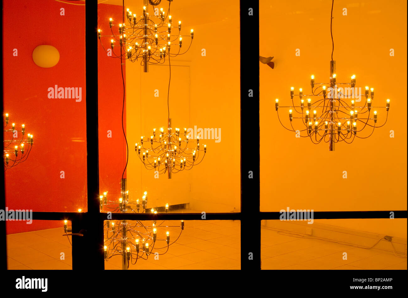 Looking through the window into an expensive lighting shop at night ...