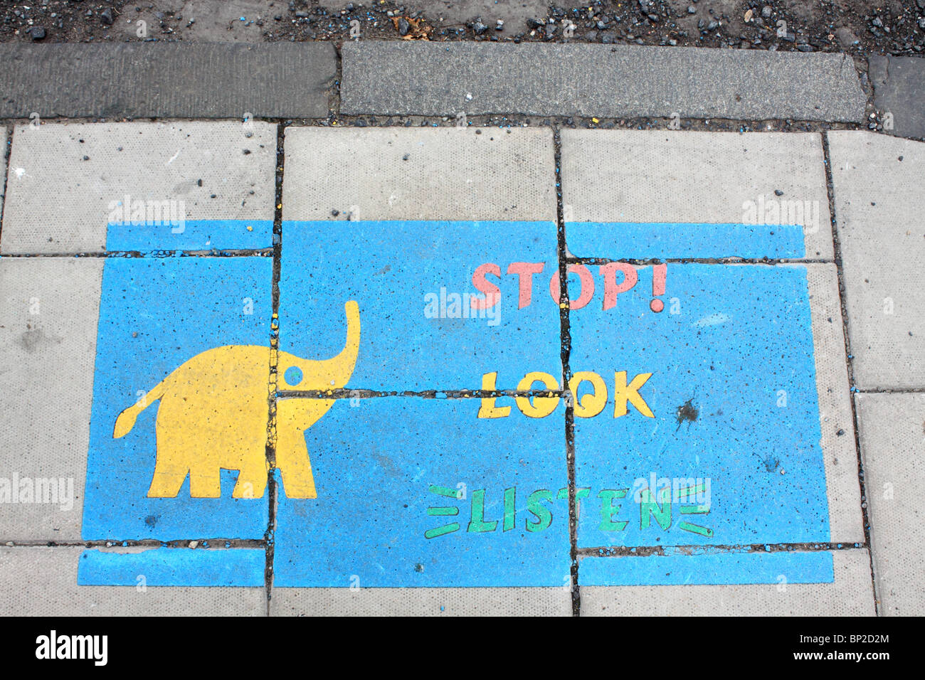 Stop - Look - Listen, children's road safety sign painted on pavement ...