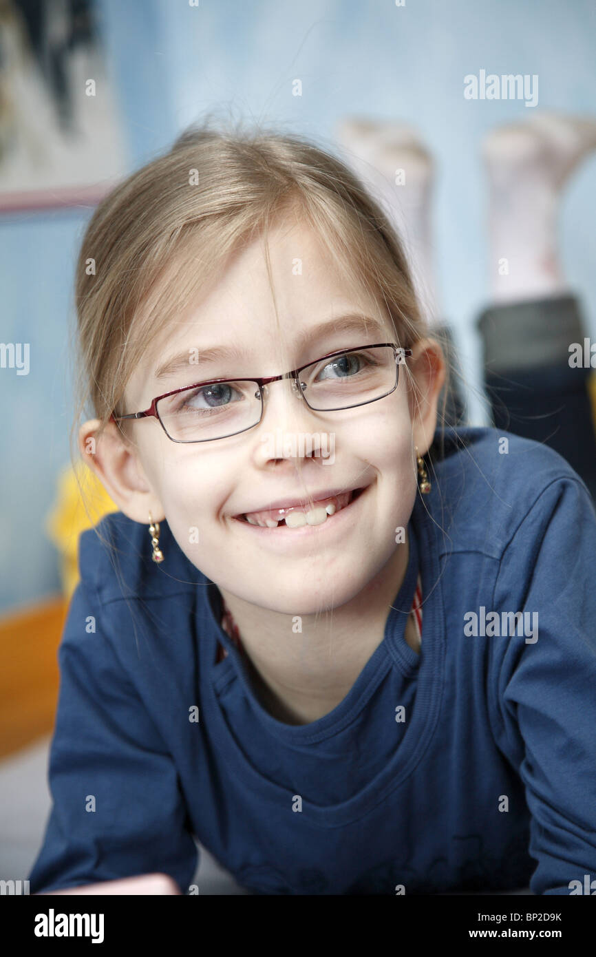 Portrait of a smiling nine-year-old girl with glasses Stock Photo - Alamy