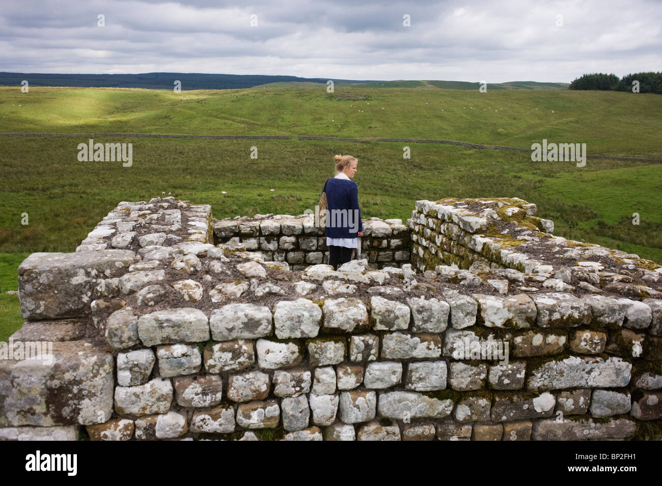 Tourist at Housesteads Fort on Roman Hadrian's Wall, once the northern ...