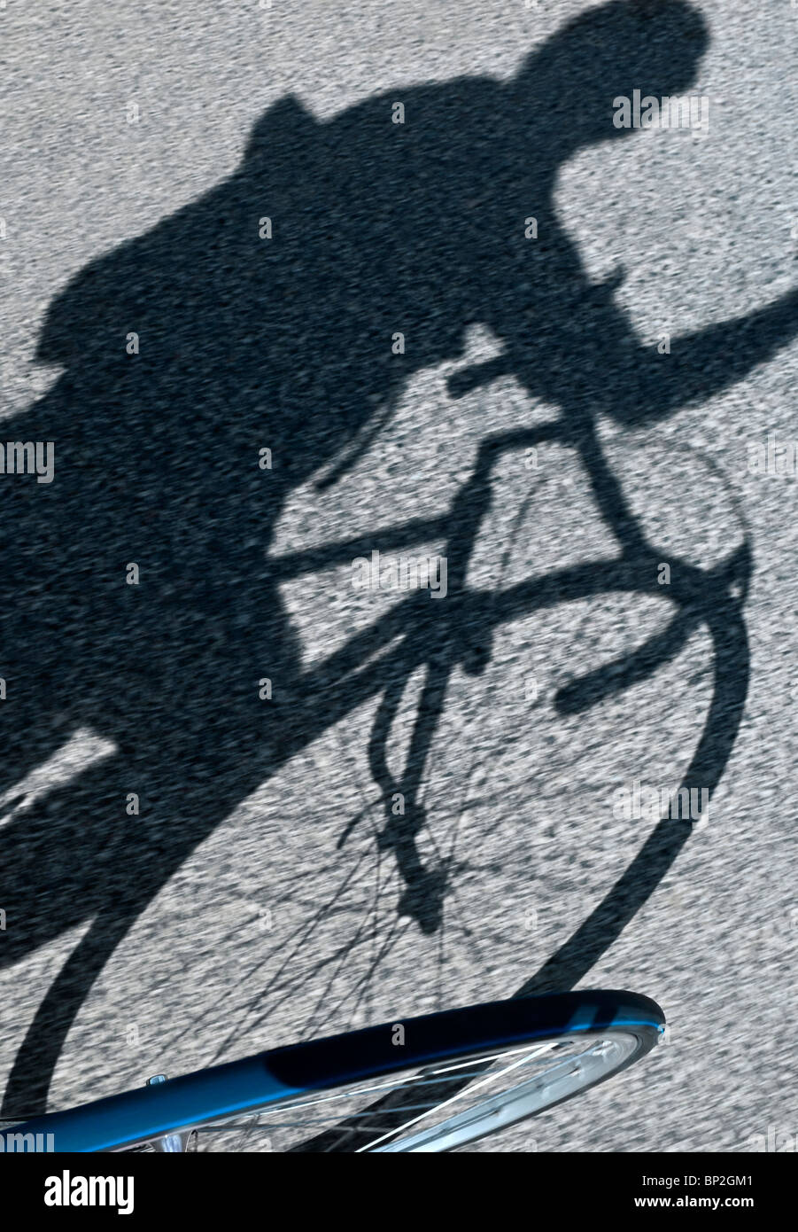 Shadow on road surface of cyclist and bicycle wheel - France Stock ...