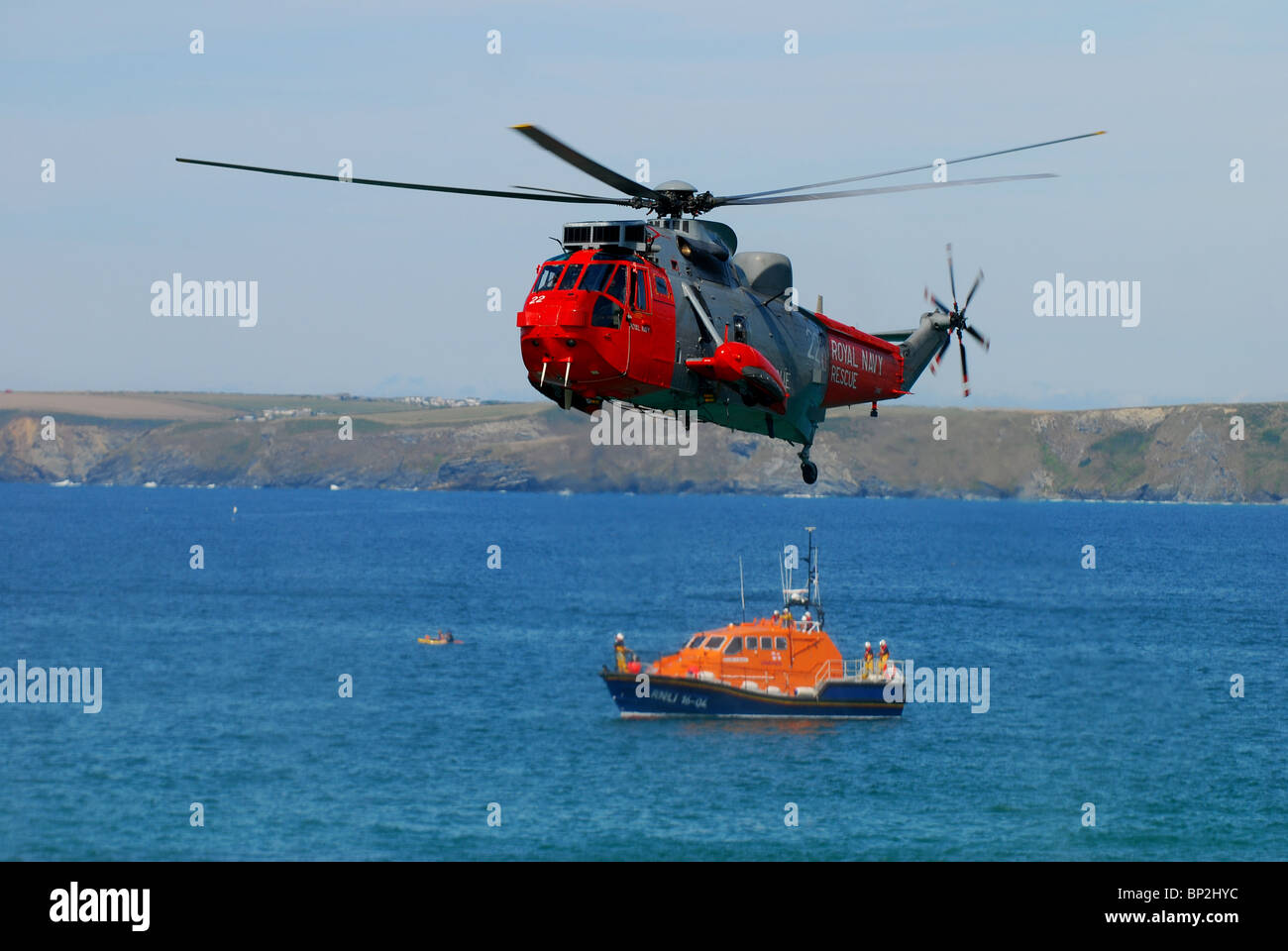 Royal Navy rescue helicopter with RNLI lifeboat in the water Stock ...