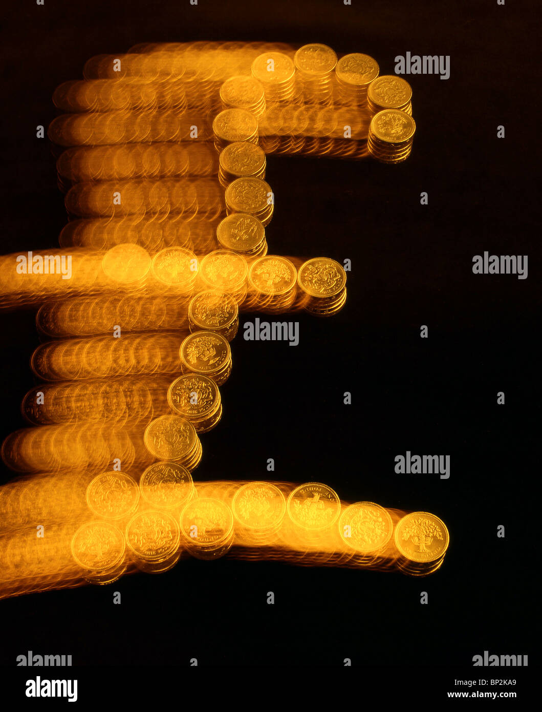 Pound sign made with pound coins on black background Stock Photo - Alamy
