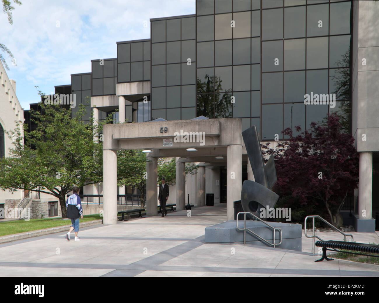 Two people entering and exiting the Robert S. K. Welch Court House in ...