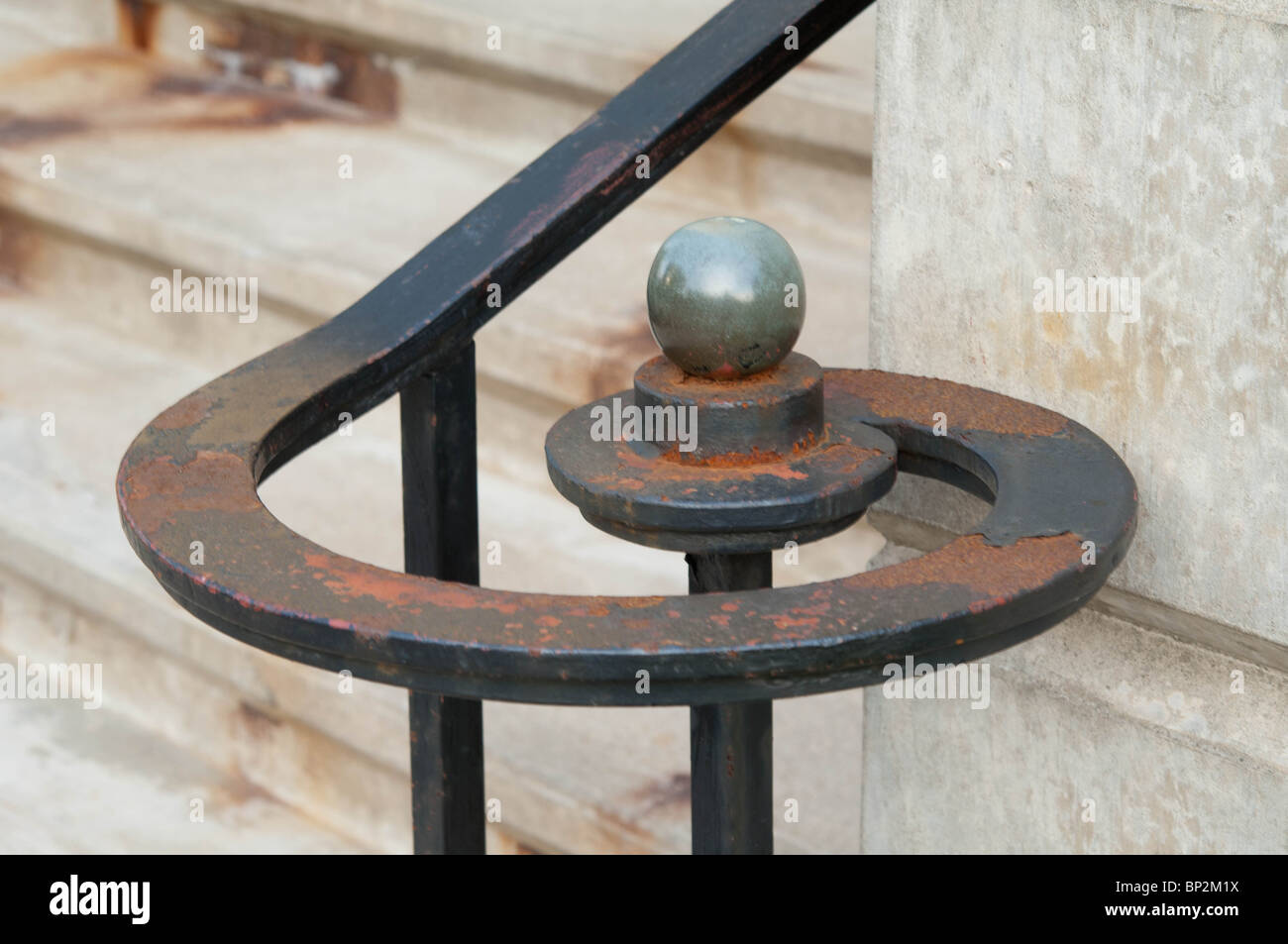 A rusty but usable wrought iron handrail provides a functional ...