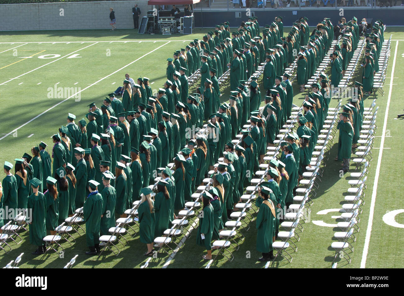 Graduates line up and stand during graduation commencement ceremony ...