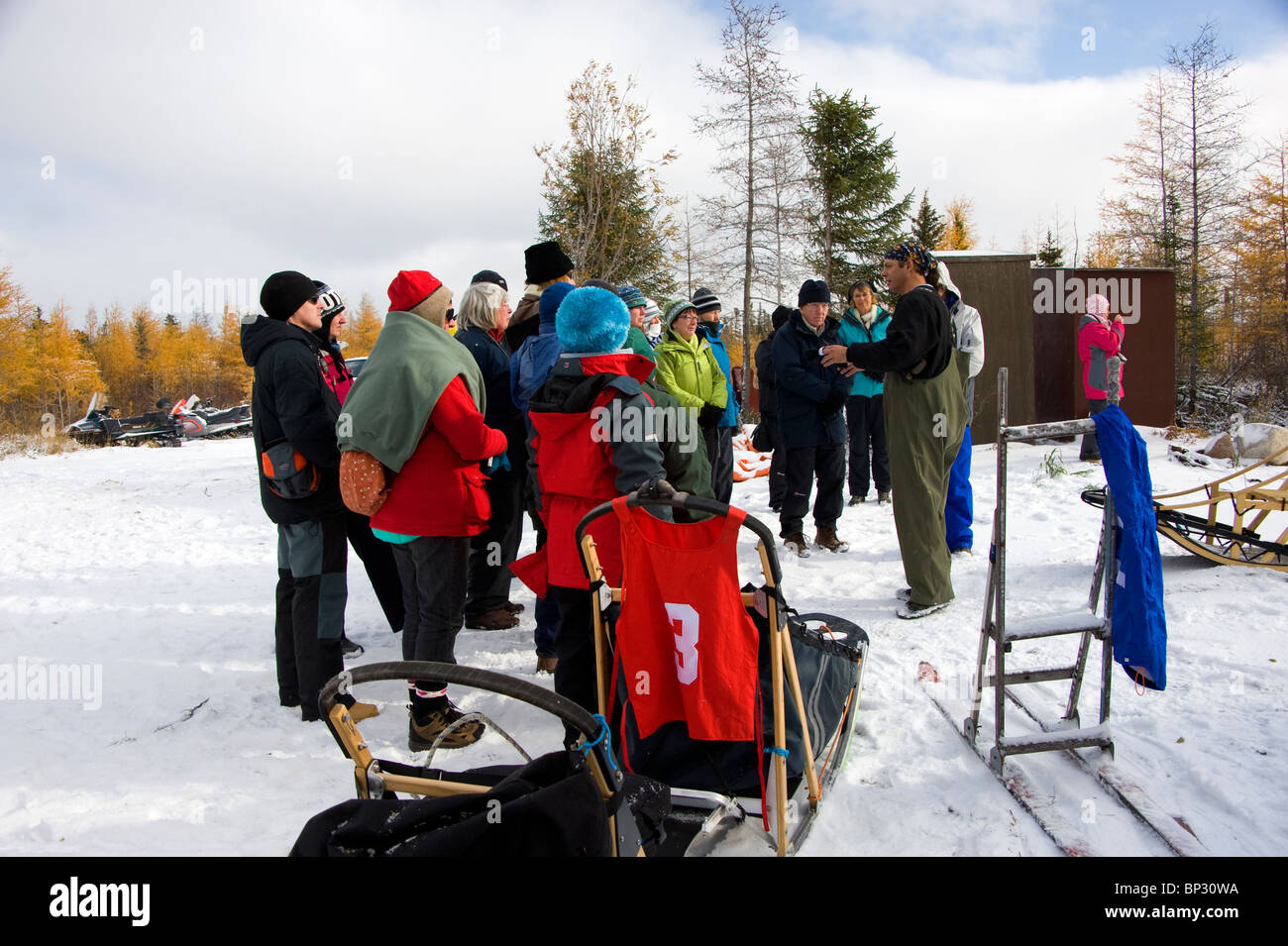 Dave Daley talking to a tour group about husky dogs and dog-sledding ...