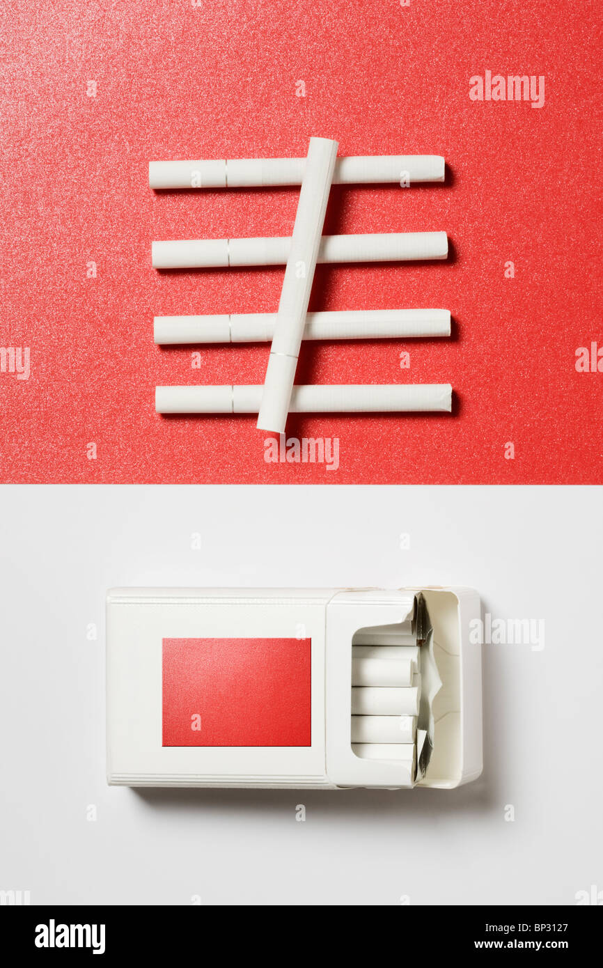 Pack of Cigarettes on white and some cigarettes on red paper background ...