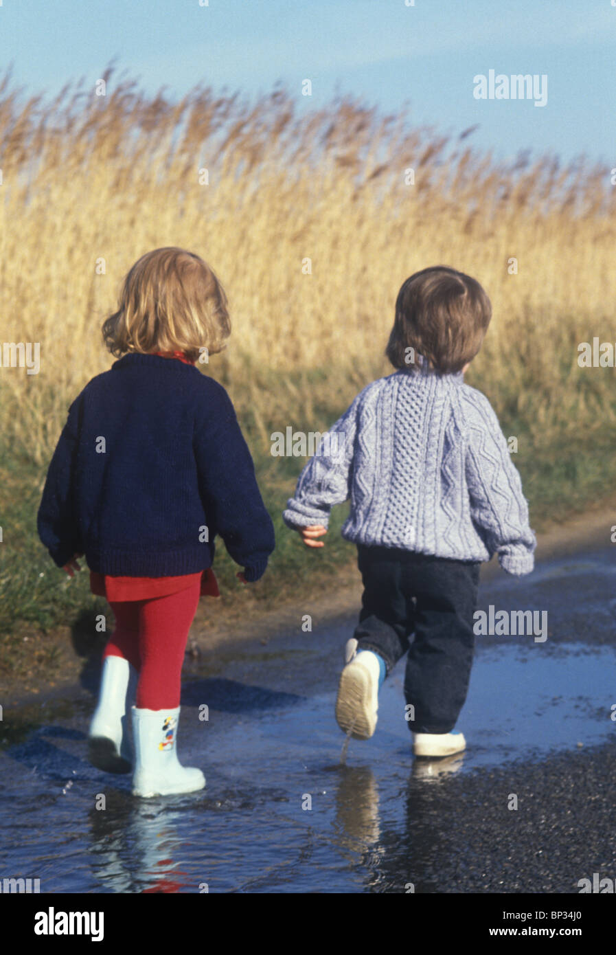 Boy walking in puddles in hi-res stock photography and images - Alamy