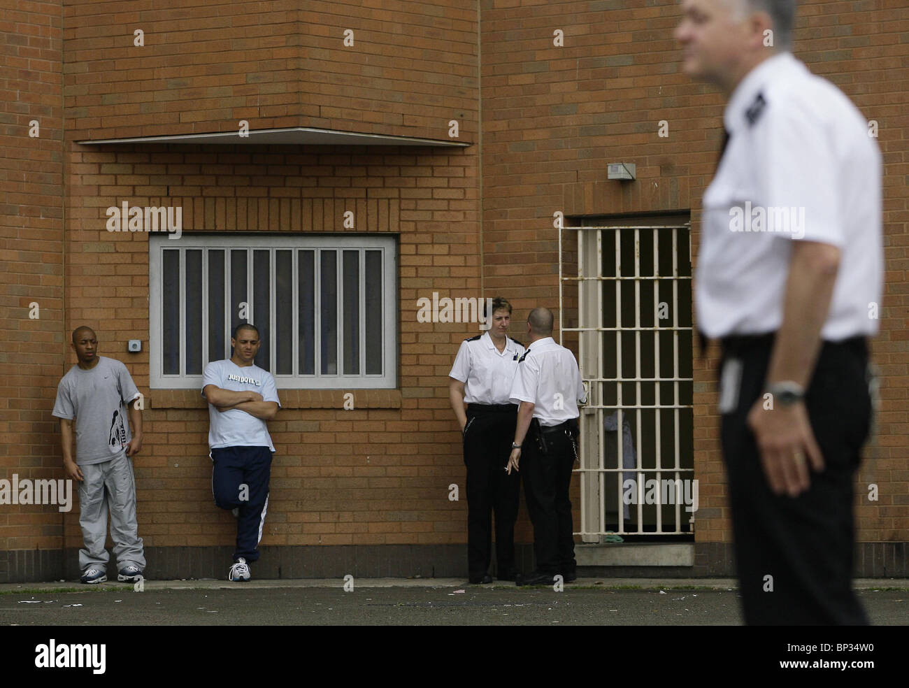 Prison Officers and prisoners in the exercise yard at HM Prison ...