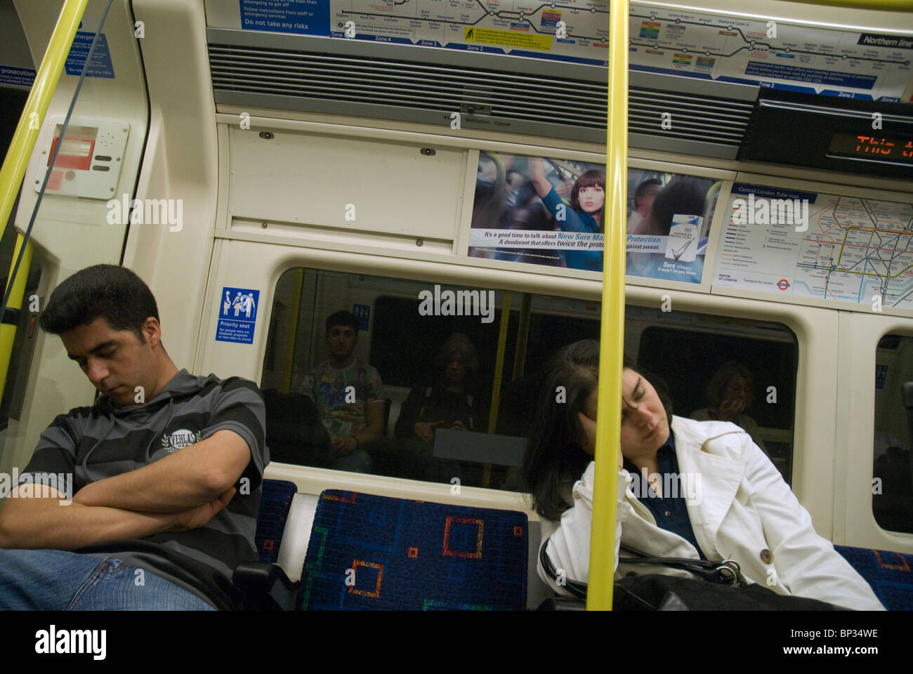 Falling asleep on the late night tube train Stock Photo - Alamy
