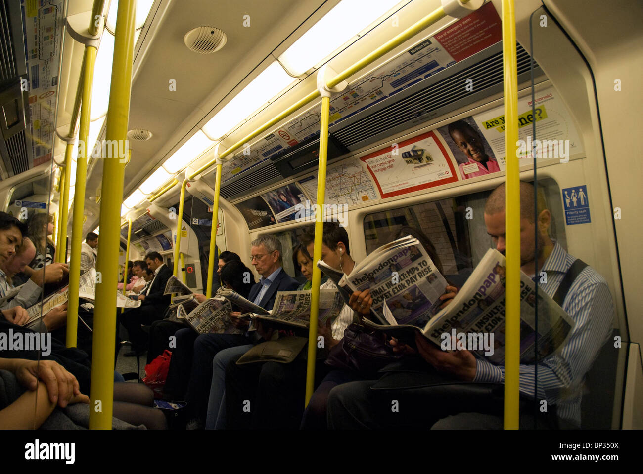 People Reading Newspaper On Train