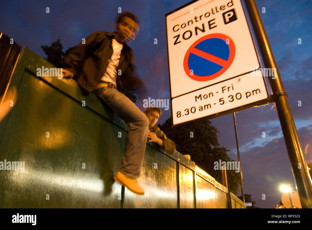 Young people escaping by climbing over high barrier after park closing ...