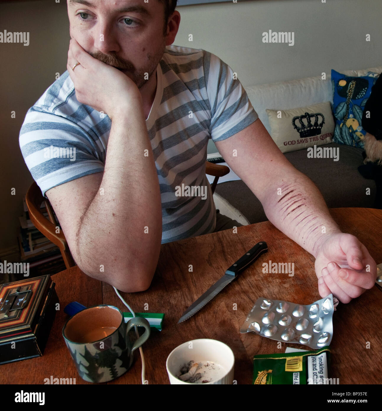 Extremely depressed young man self harming and suicidal Stock Photo - Alamy