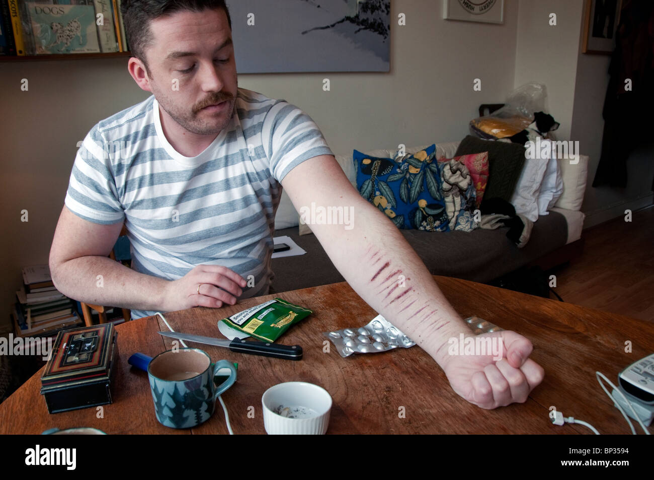 Extremely depressed young man self harming and suicidal Stock Photo - Alamy