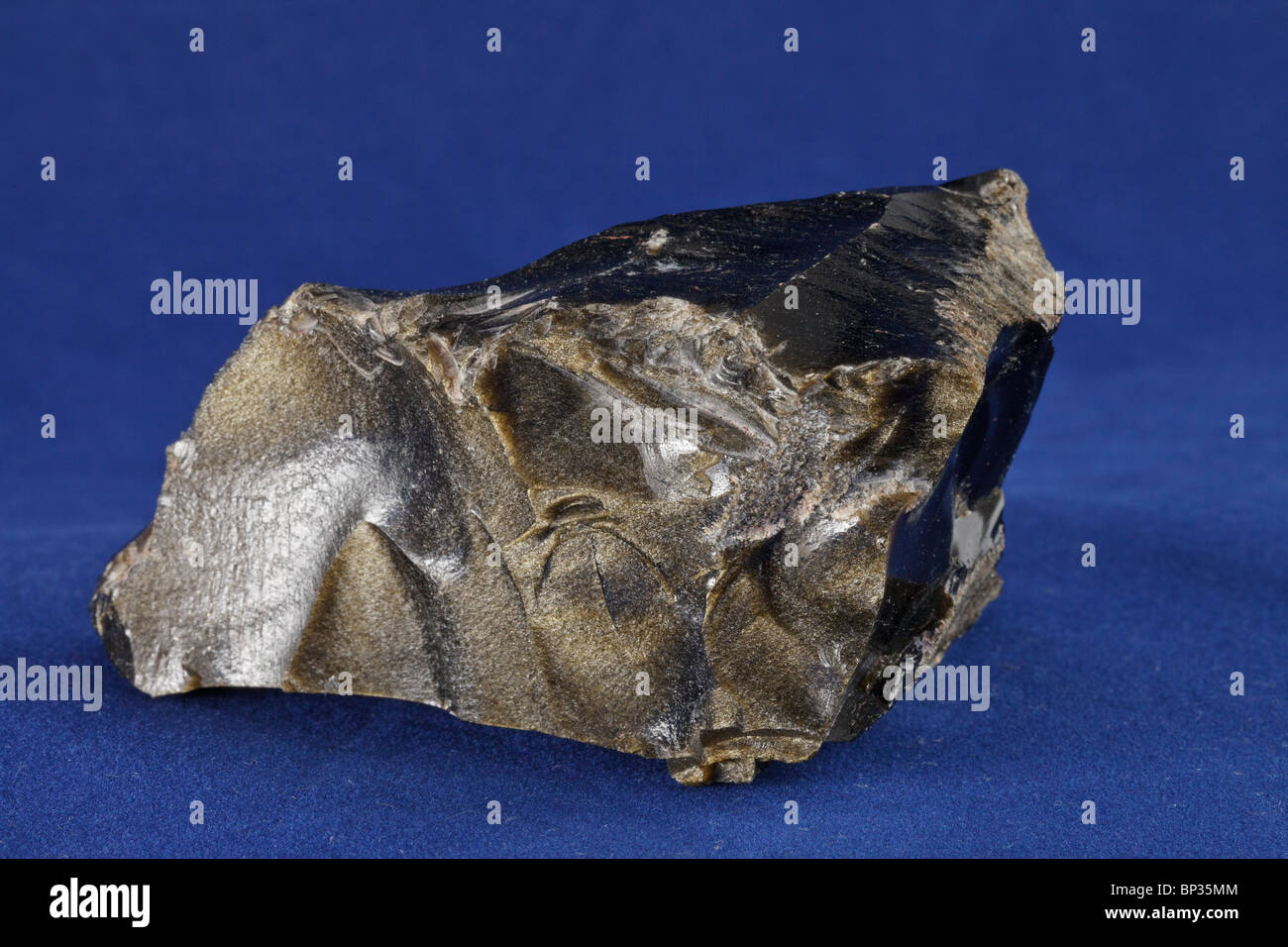 Rare, "lunar" obsidian from Teotihuacan, Mexico on a blue background ...
