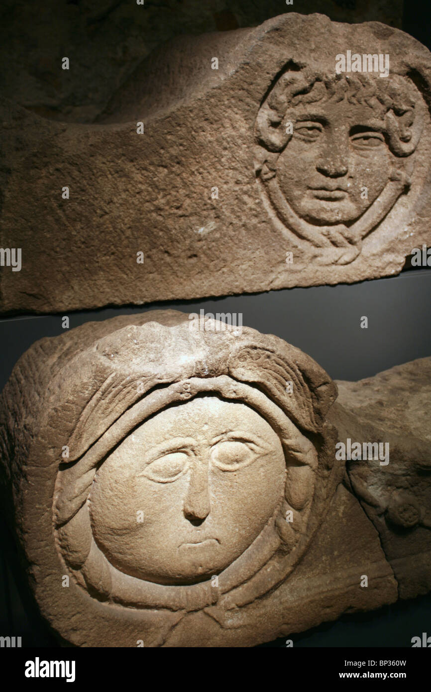 Roman stone carvings of two faces displayed underground in the ...