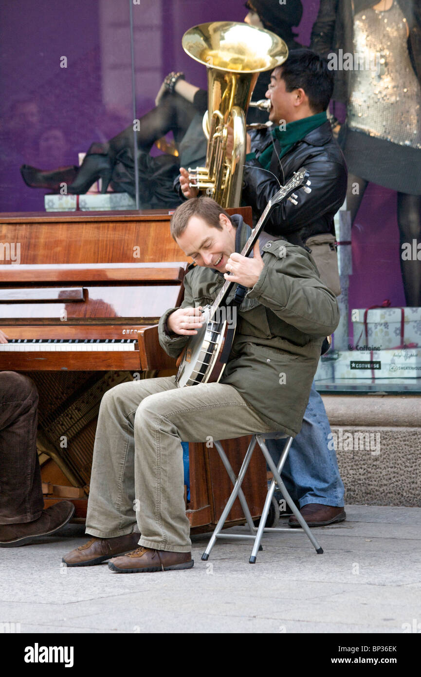 Street buskers with a piano, banjo, trumpet and tuba play in Avinguda ...