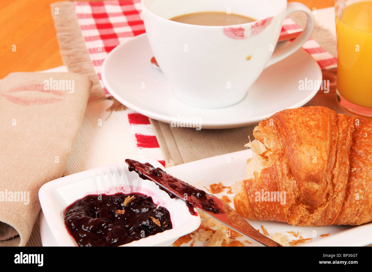 A finished breakfast of a croissant and jelly Stock Photo - Alamy