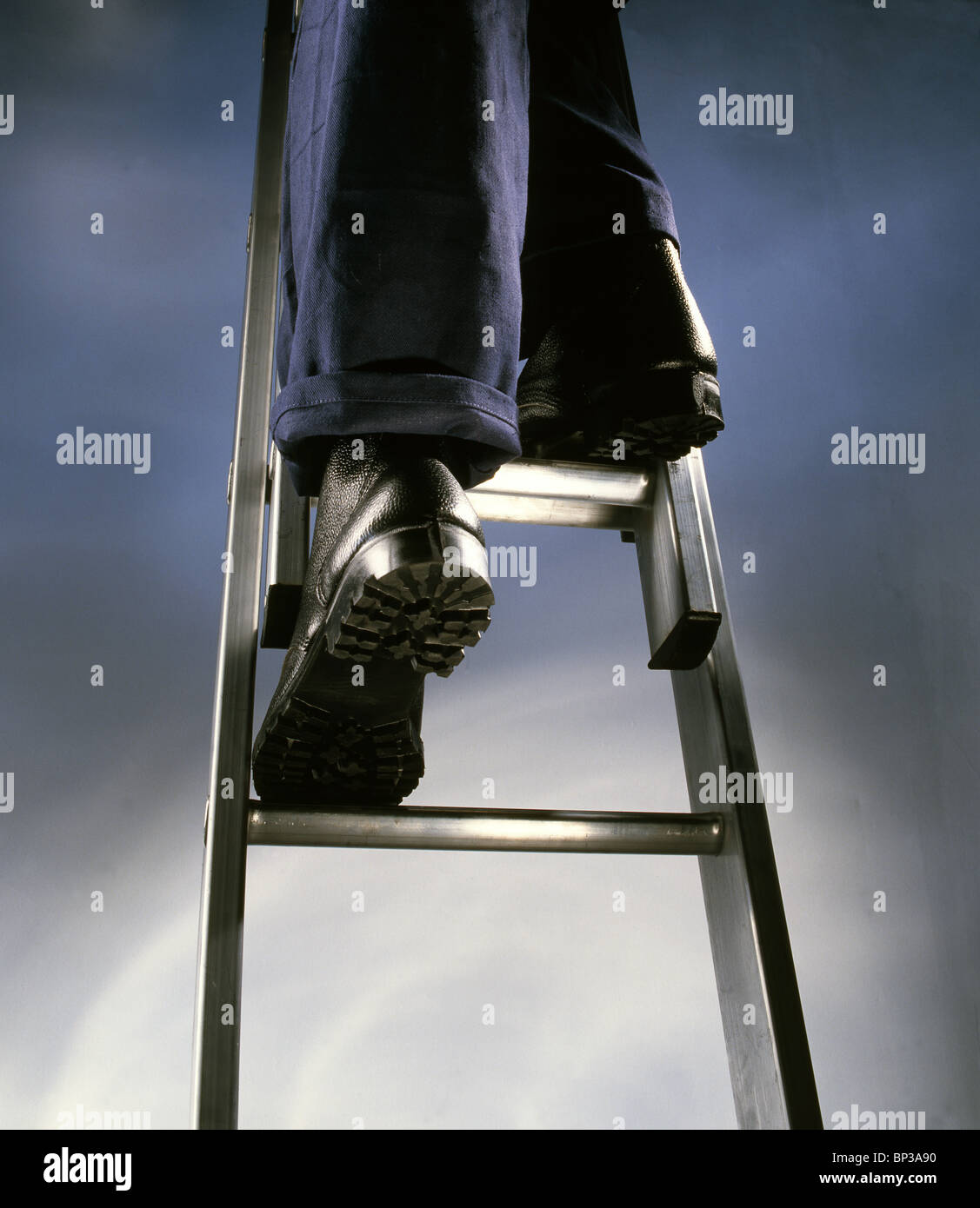 Workman on steel Ladder with black boots and overalls Stock Photo - Alamy