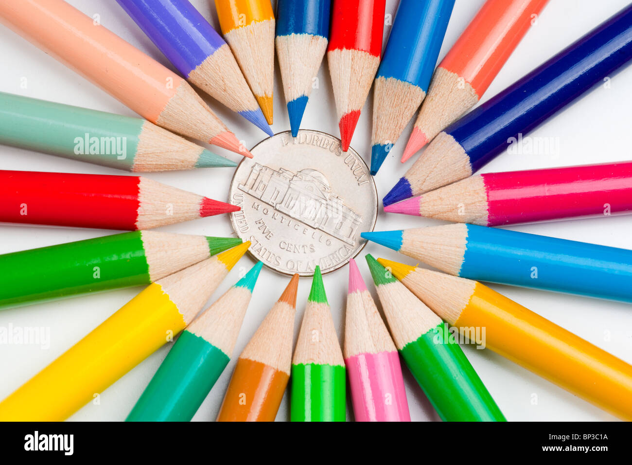Nickel coin in a circle of color pencils Stock Photo - Alamy