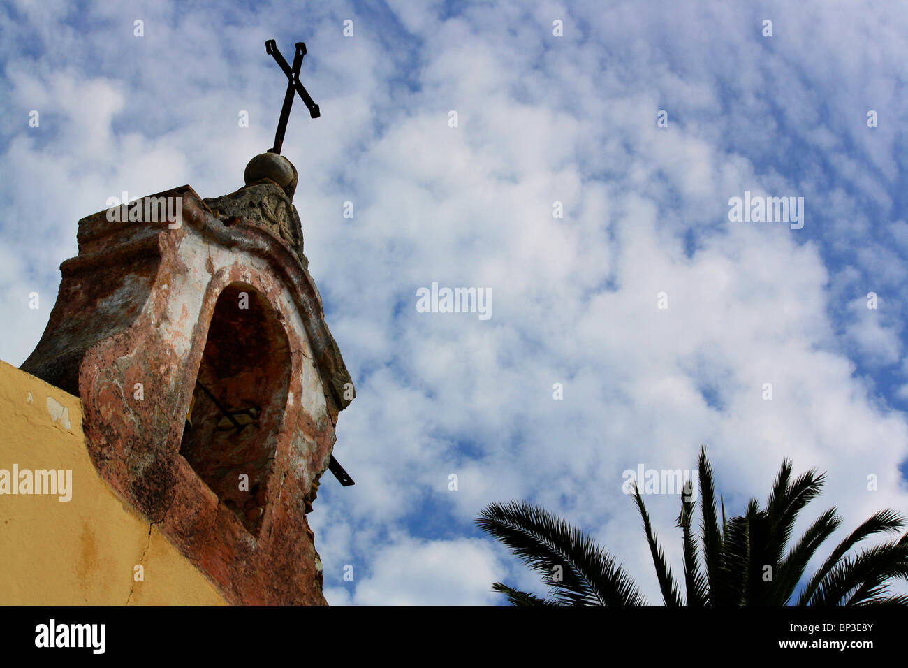 Bell tower and cross of a small Italian church against blue sky Stock ...