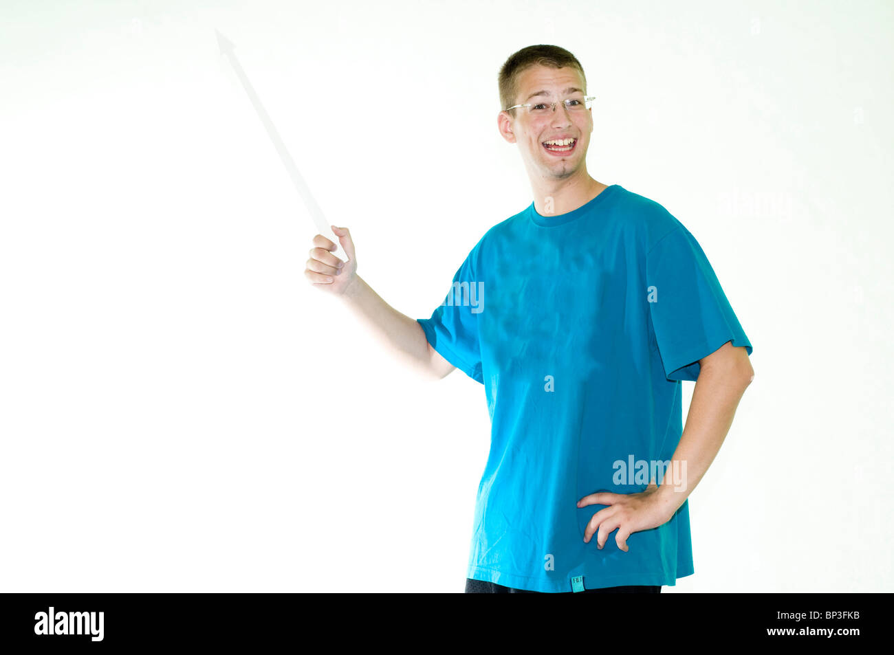 Young, happy man pointing things with his indicator, isolated on white ...
