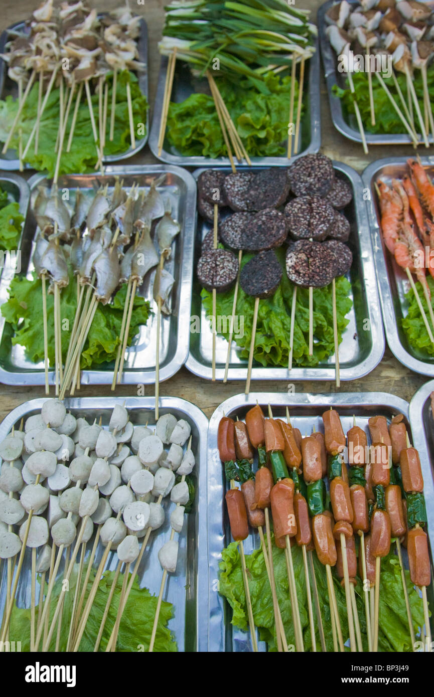 CHINA, Yunnan Province, Lijiang. Old Town, Snacks at outdoor grill ...