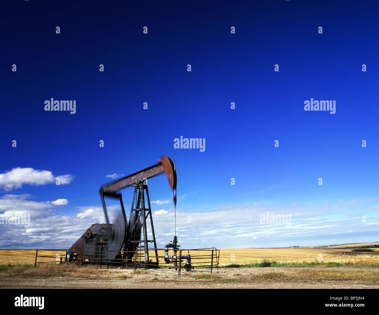 An oil well with the pump jack in action. Located in the province of ...