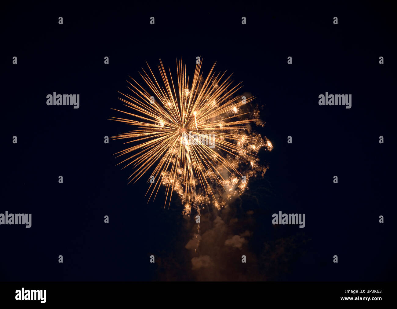 multi coloured fireworks erupting in the night sky over water Stock ...