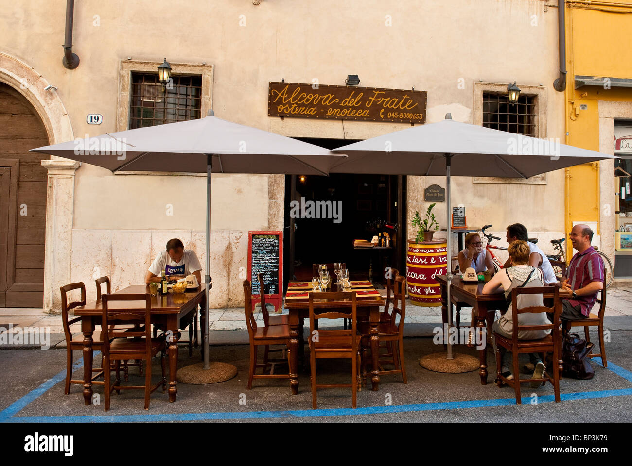 People eating outdoors at traditional trattoria, Verona Italy Stock ...