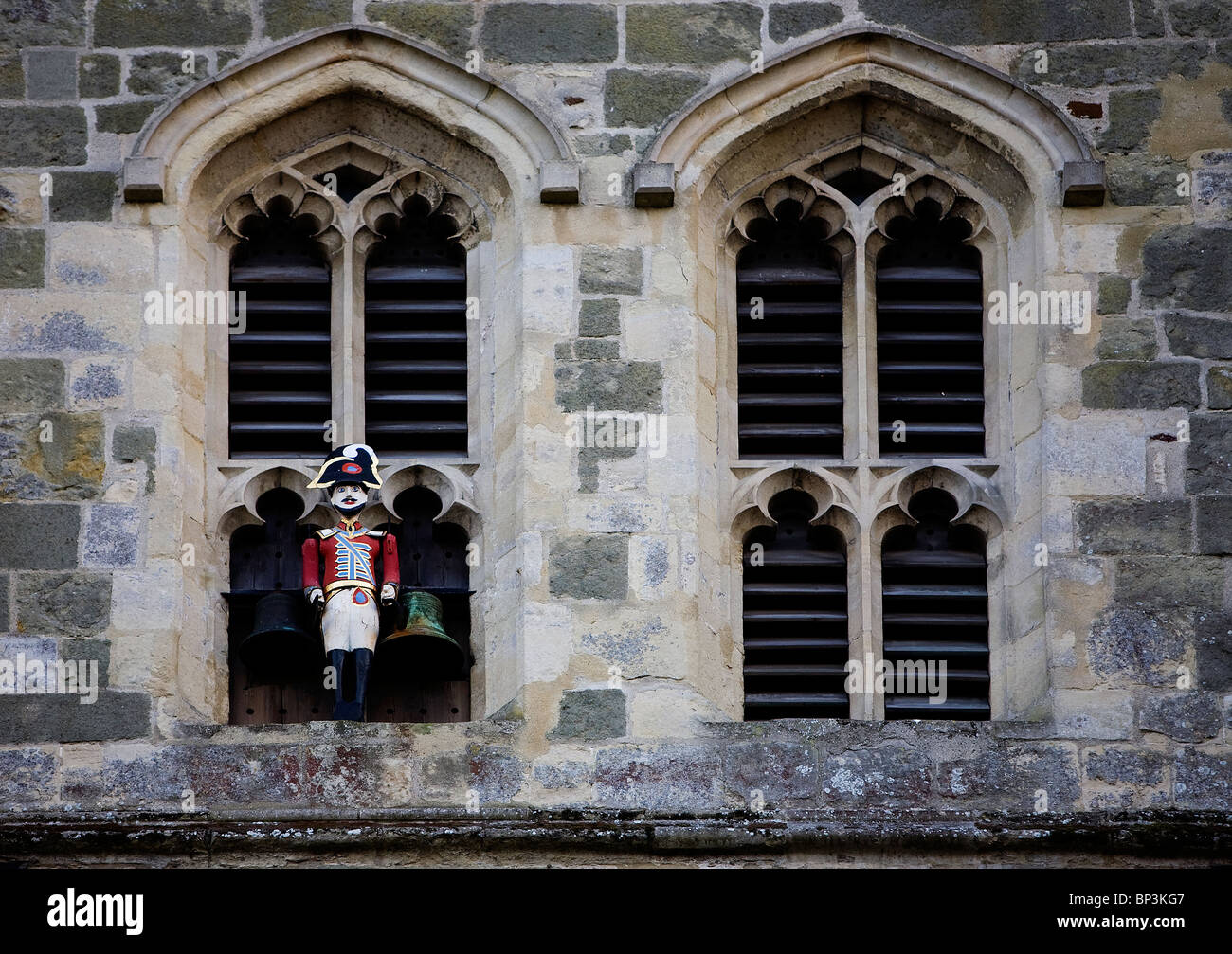 Low viewpoint of the west tower of Wimborne Minster viewed in autumn ...