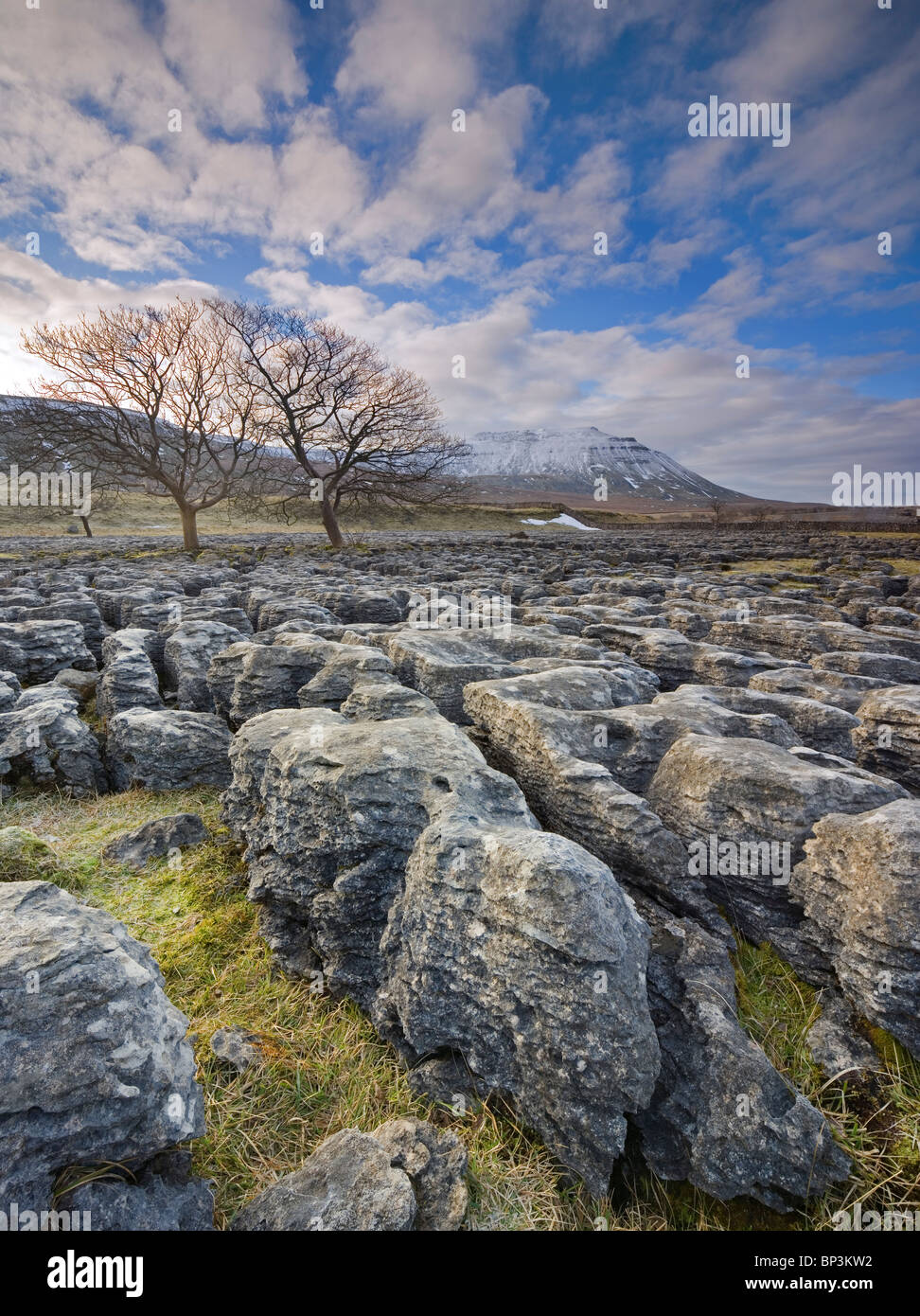 Limestone pavement at the foot of snow capped Ingleborough Hill at ...