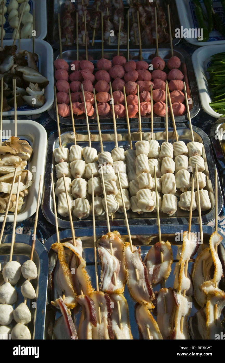 CHINA, Yunnan Province, Lijiang. Old Town, Snacks at outdoor grill ...