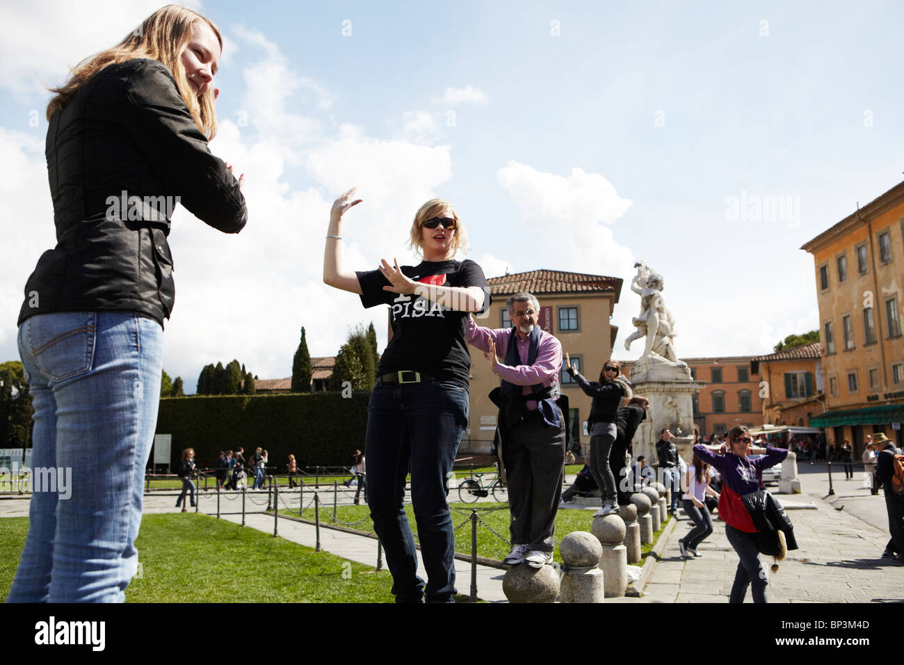 Tourists posing at the Leaning Tower of Pisa in Pisa, Italy Stock Photo ...
