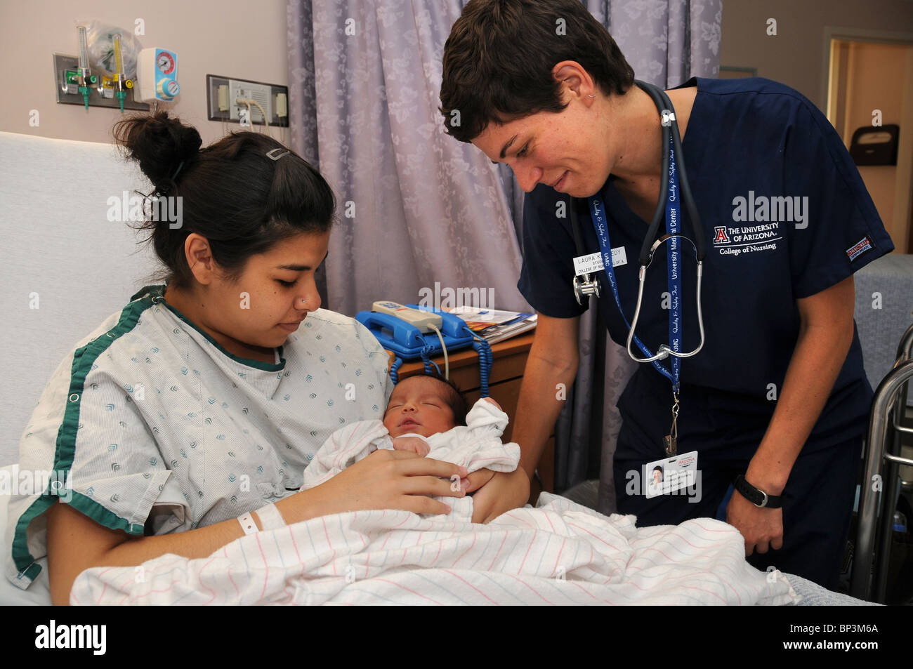 A mother and her 2-day-old infant with a nursing student at a hospital ...
