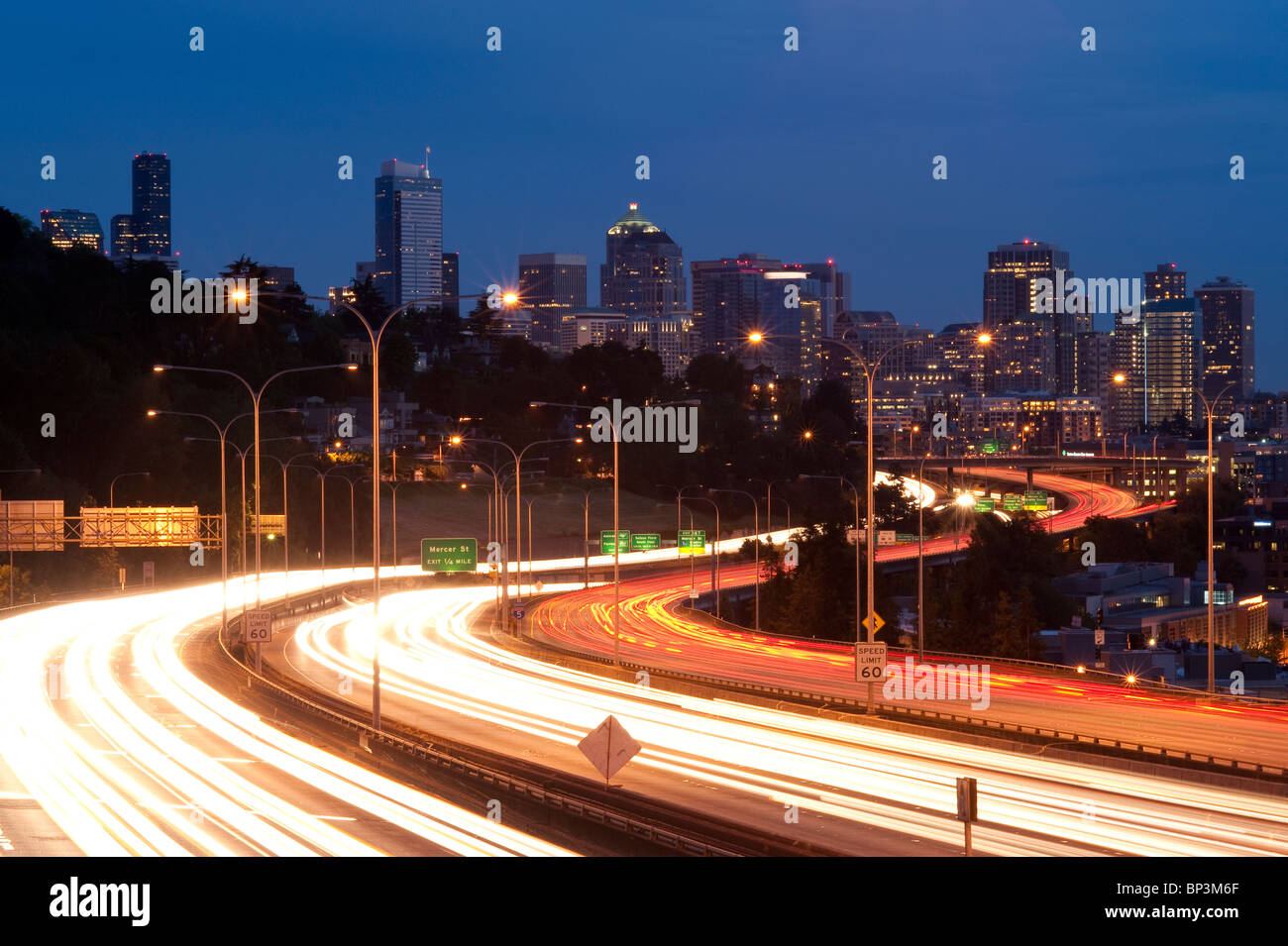 Retro image of Seattle skyline with freeway traffic on I-5 at twilight ...