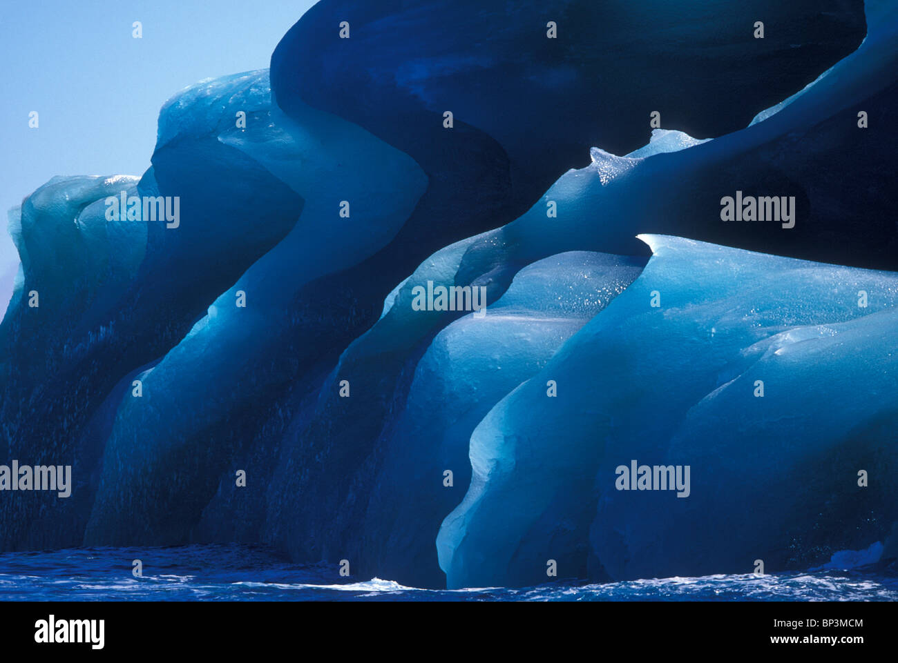 Antarctica, Morning sun lights deep blue iceberg floating north of ...
