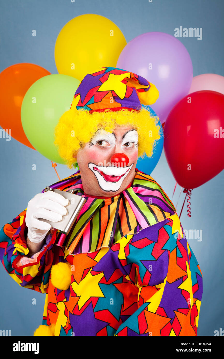 Humorous picture of an alcoholic clown sneaking a drink from his flask ...