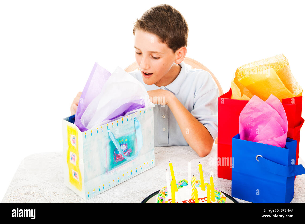 Cute little boy opening his birthday presents. White background Stock ...