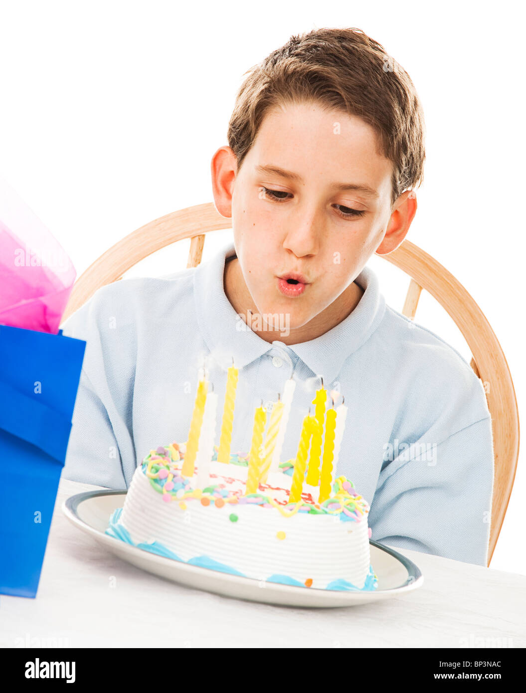 Birthday boy blowing out the candles on his cake Stock Photo - Alamy