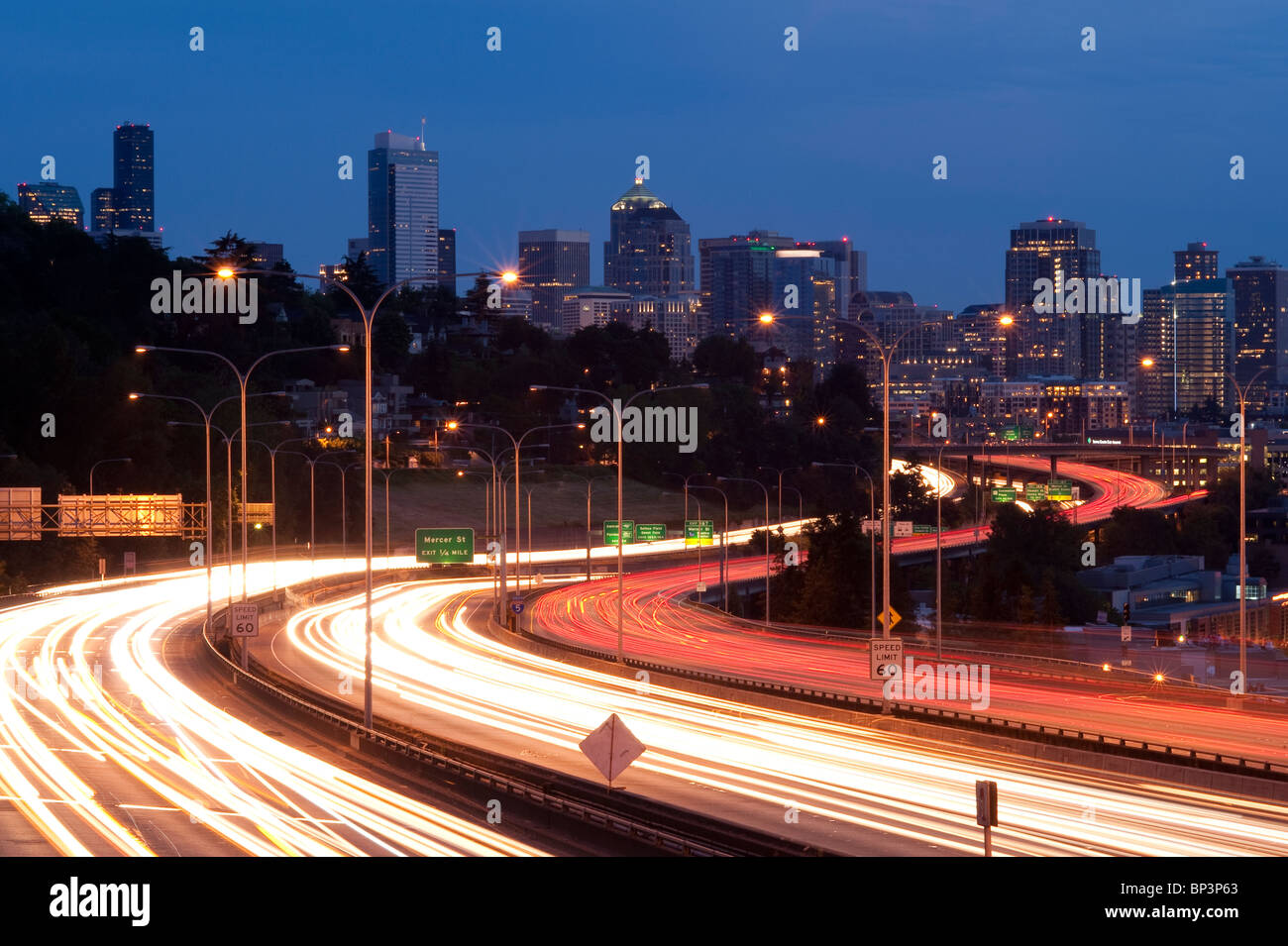 Retro image of Seattle skyline with freeway traffic on I-5 at twilight ...